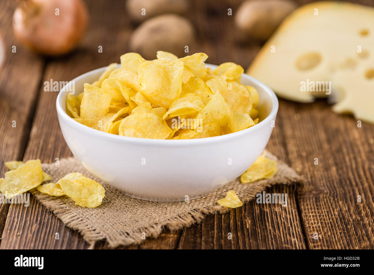 Cheese and Onion Potato Chips on a vintage background as detailed close ...