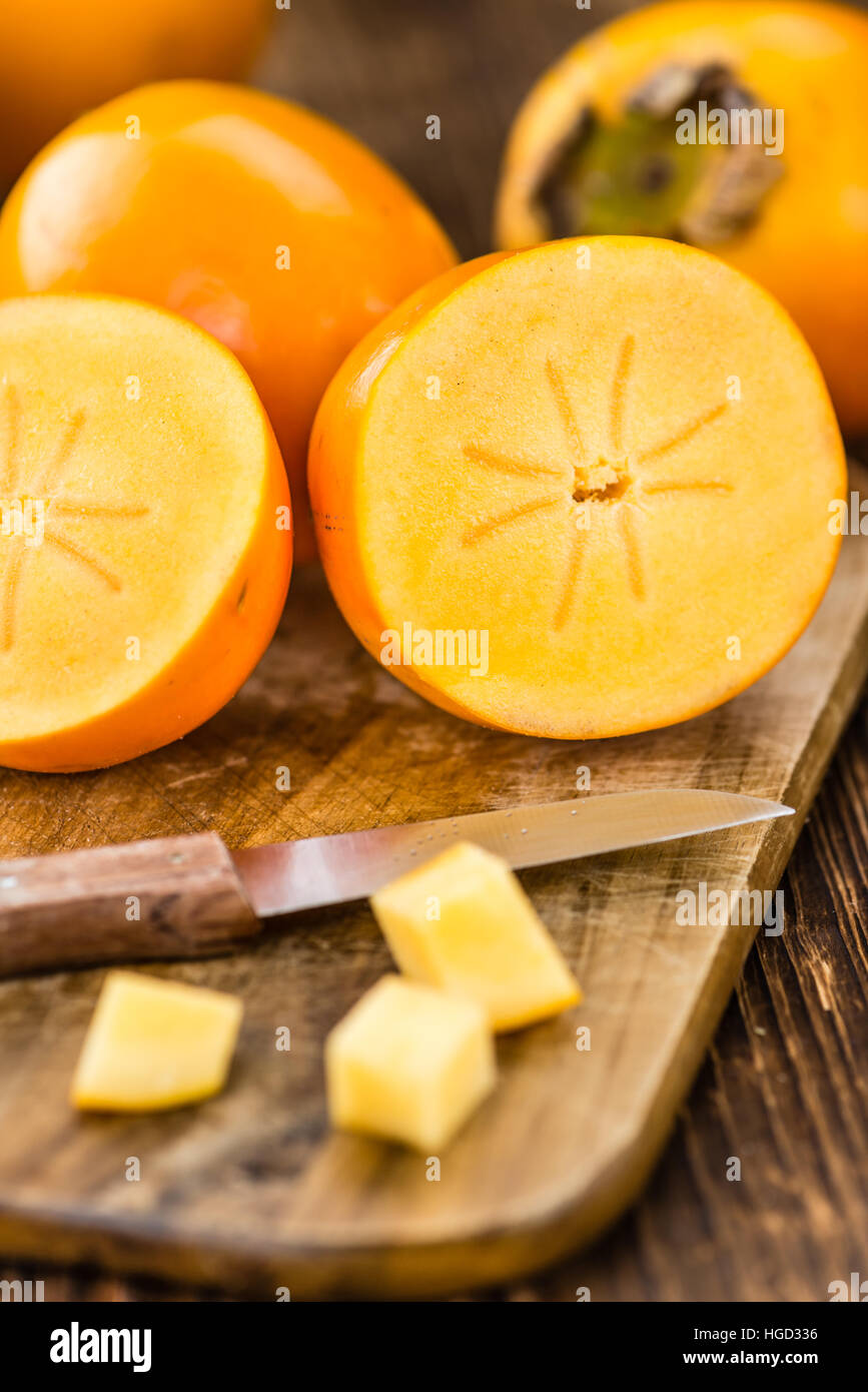 Kaki fruits on a vintage background as detailed close-up shot ...