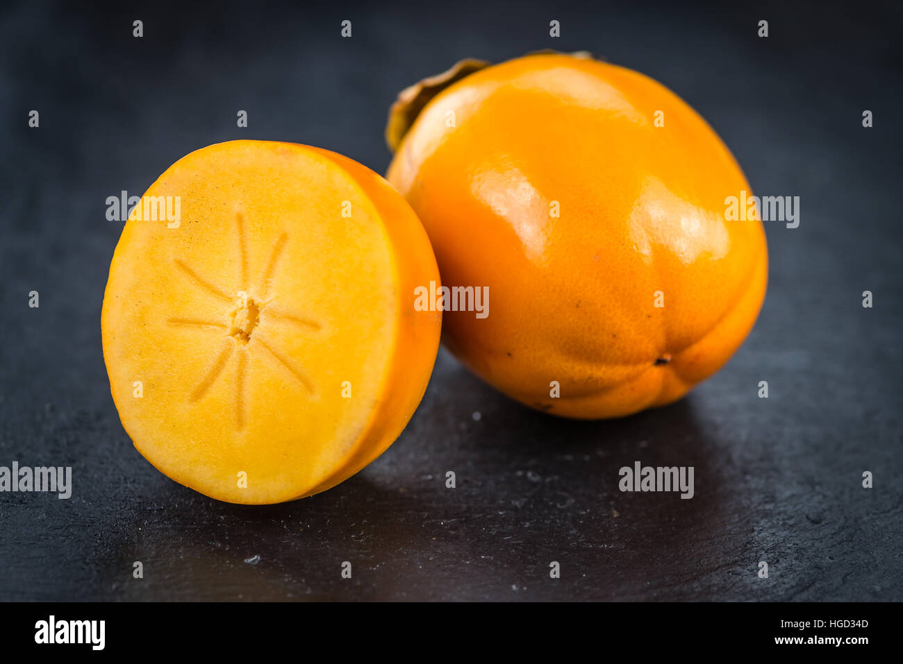 Kaki fruits on a vintage background as detailed close-up shot ...