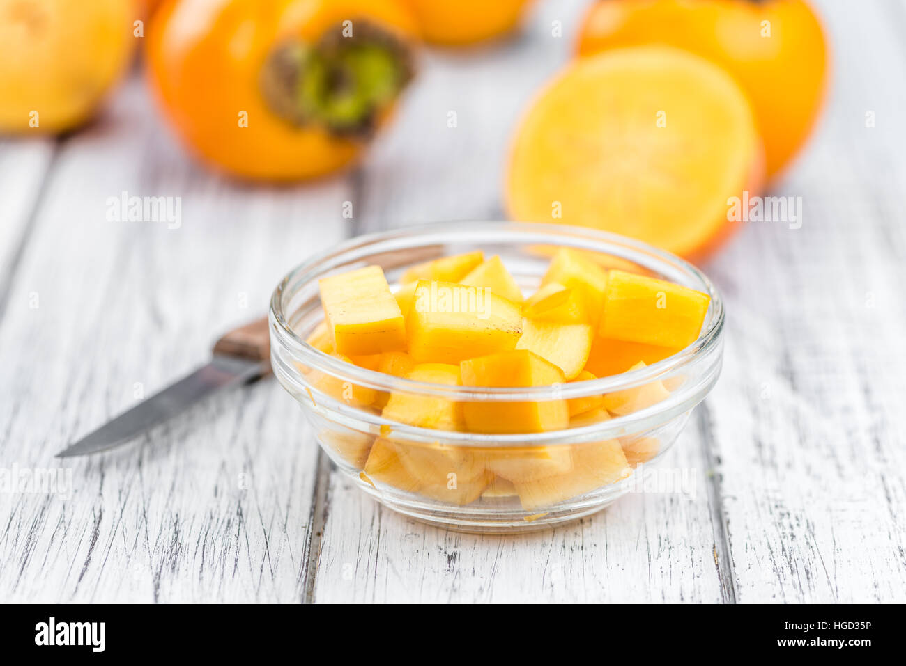 Kaki fruits on rustic wooden background (close-up shot Stock Photo - Alamy
