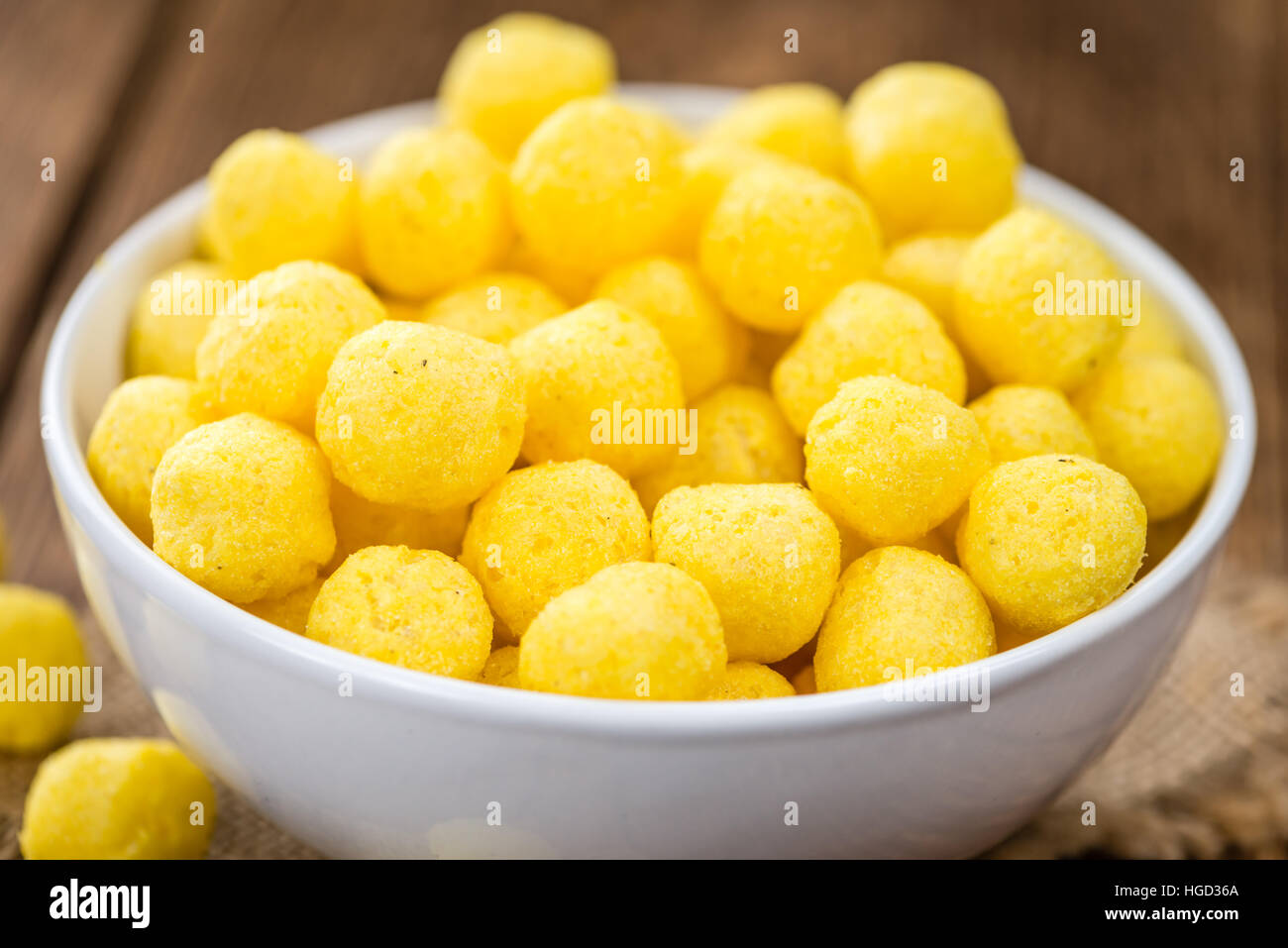 Cheese Balls on an old wooden table as detailed close-up shot ...