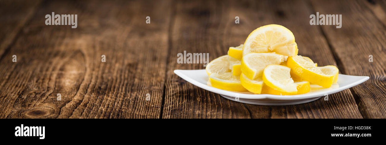 Fresh made Lemon (sliced) on an old and rustic wooden table (selective ...