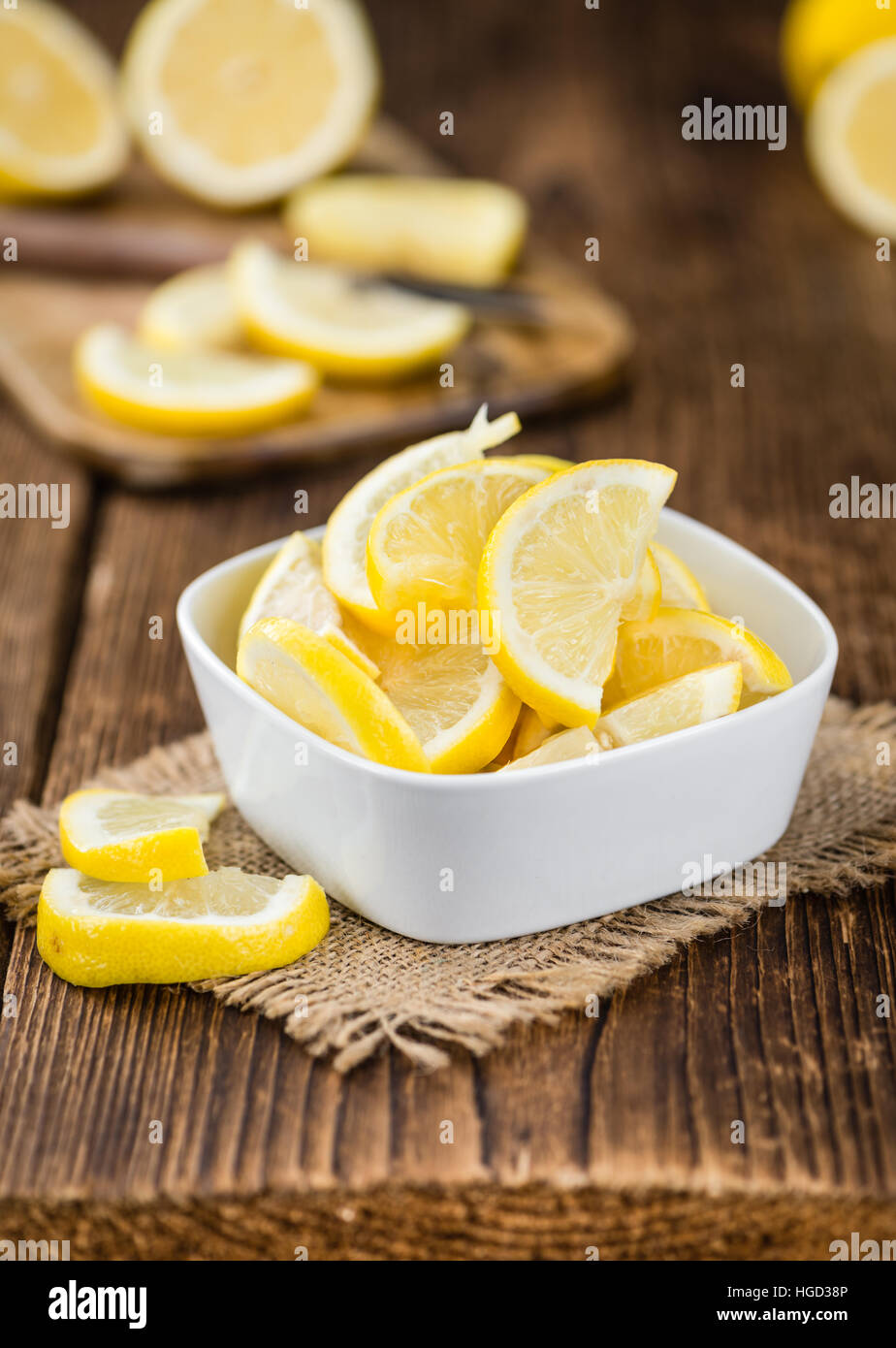 Fresh made Lemon (sliced) on a vintage background (close-up shot Stock ...