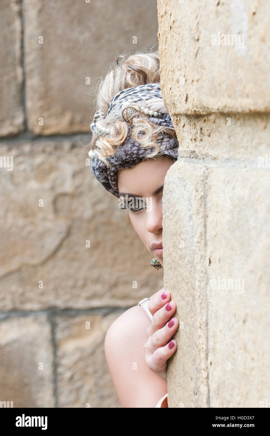Woman hiding behind a wall Stock Photo - Alamy