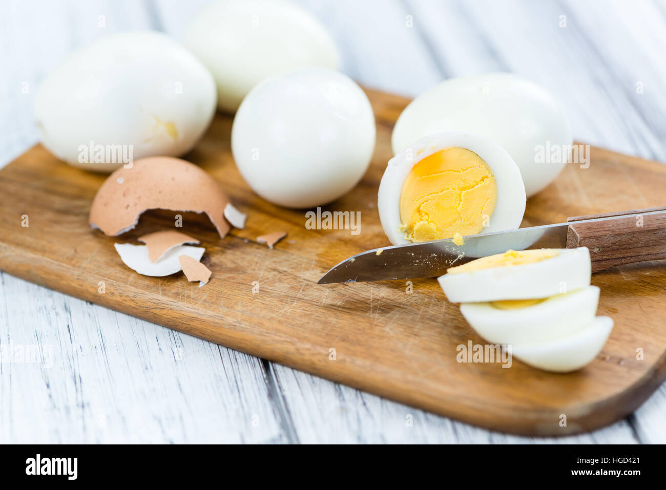 Portion of sliced Eggs (on wooden background) as close-up shot ...