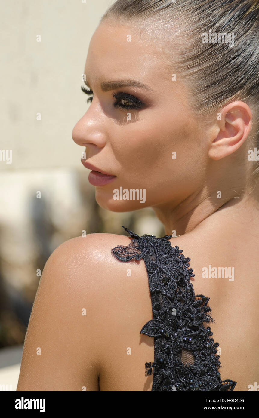 Serious woman looking over shoulder Stock Photo - Alamy
