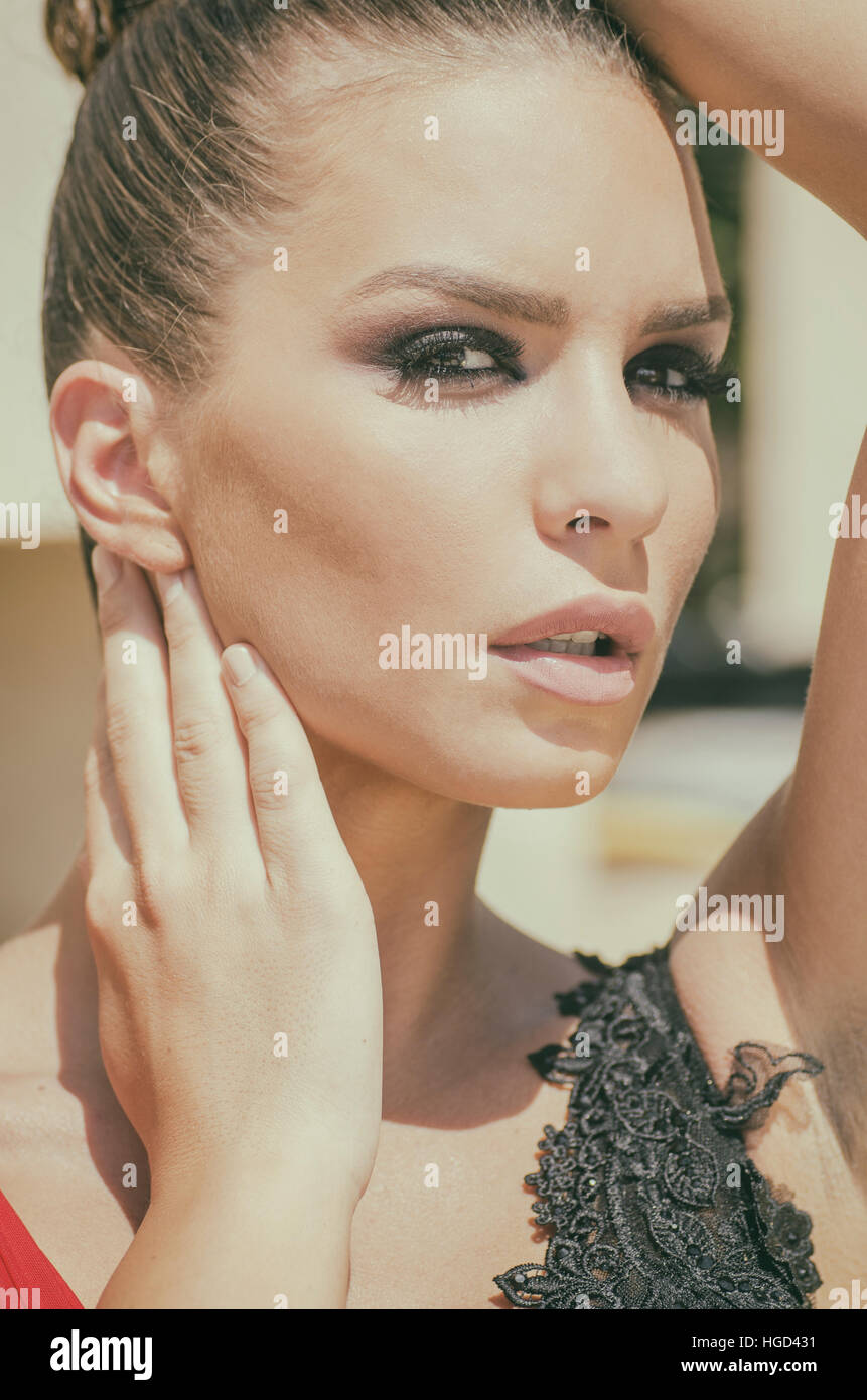 Beautiful young woman hand touching neck Stock Photo - Alamy