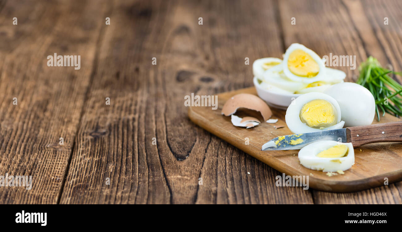 Portion of boiled Eggs (sliced) on vintage looking background ...