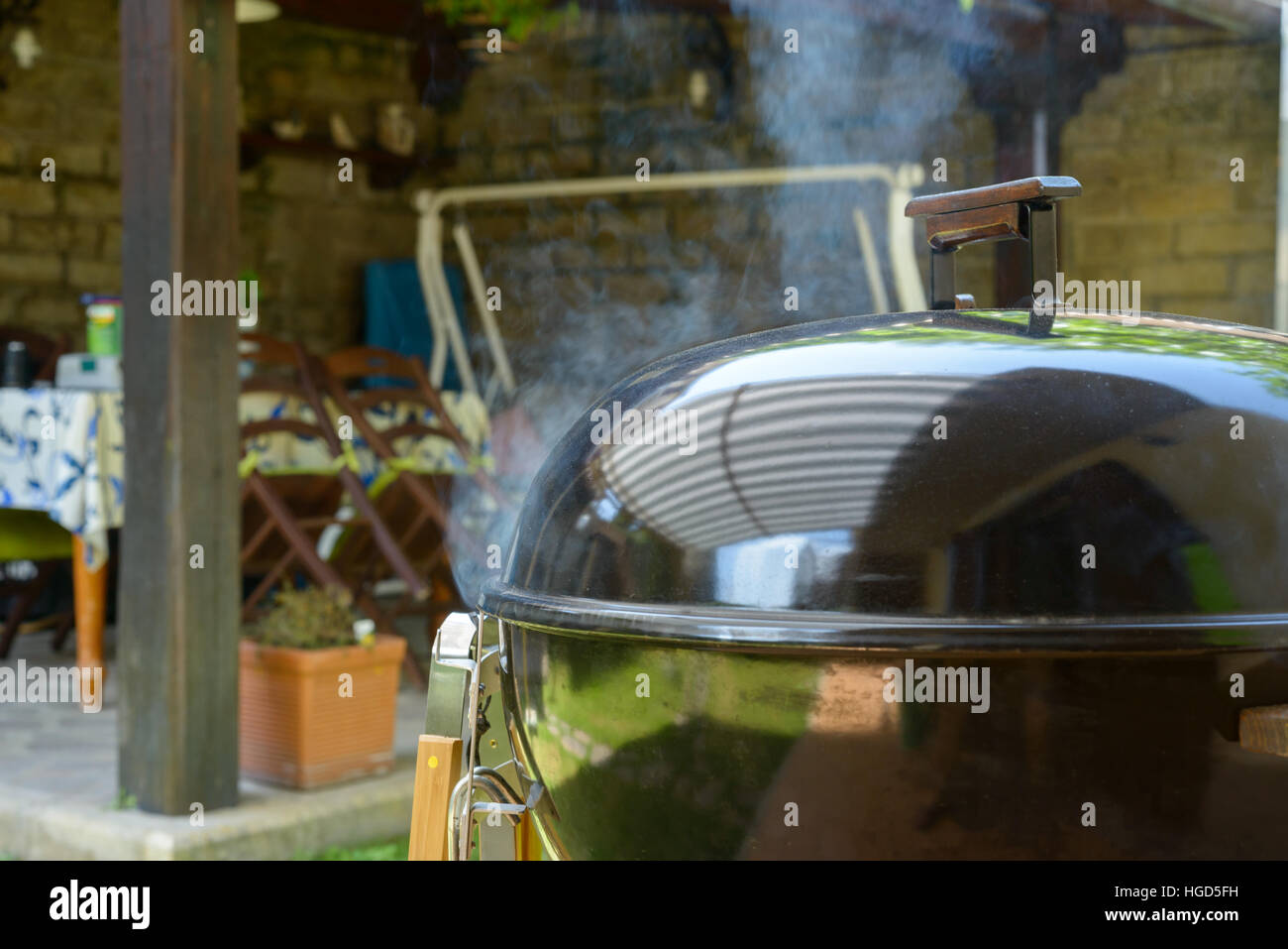 Smoke go out from a closed barbecue during pulled pork grill Stock ...
