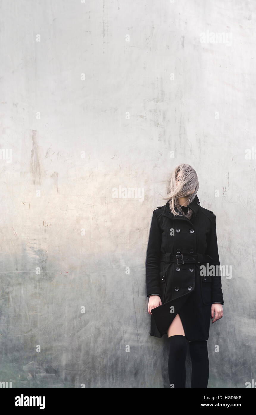 Blond young girl on metallic background in provocative pose with ...