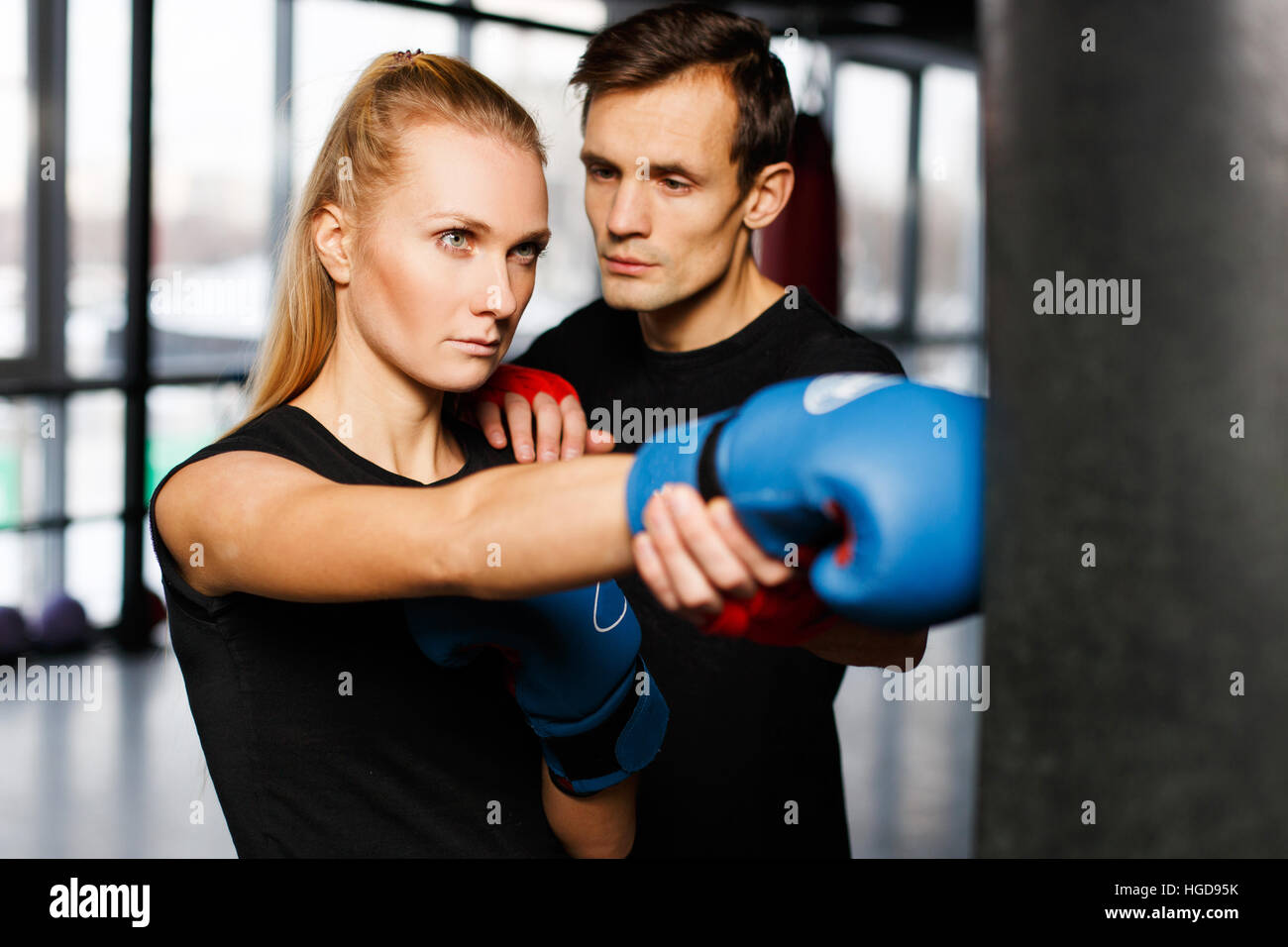 Boxing coach trains young woman Stock Photo - Alamy