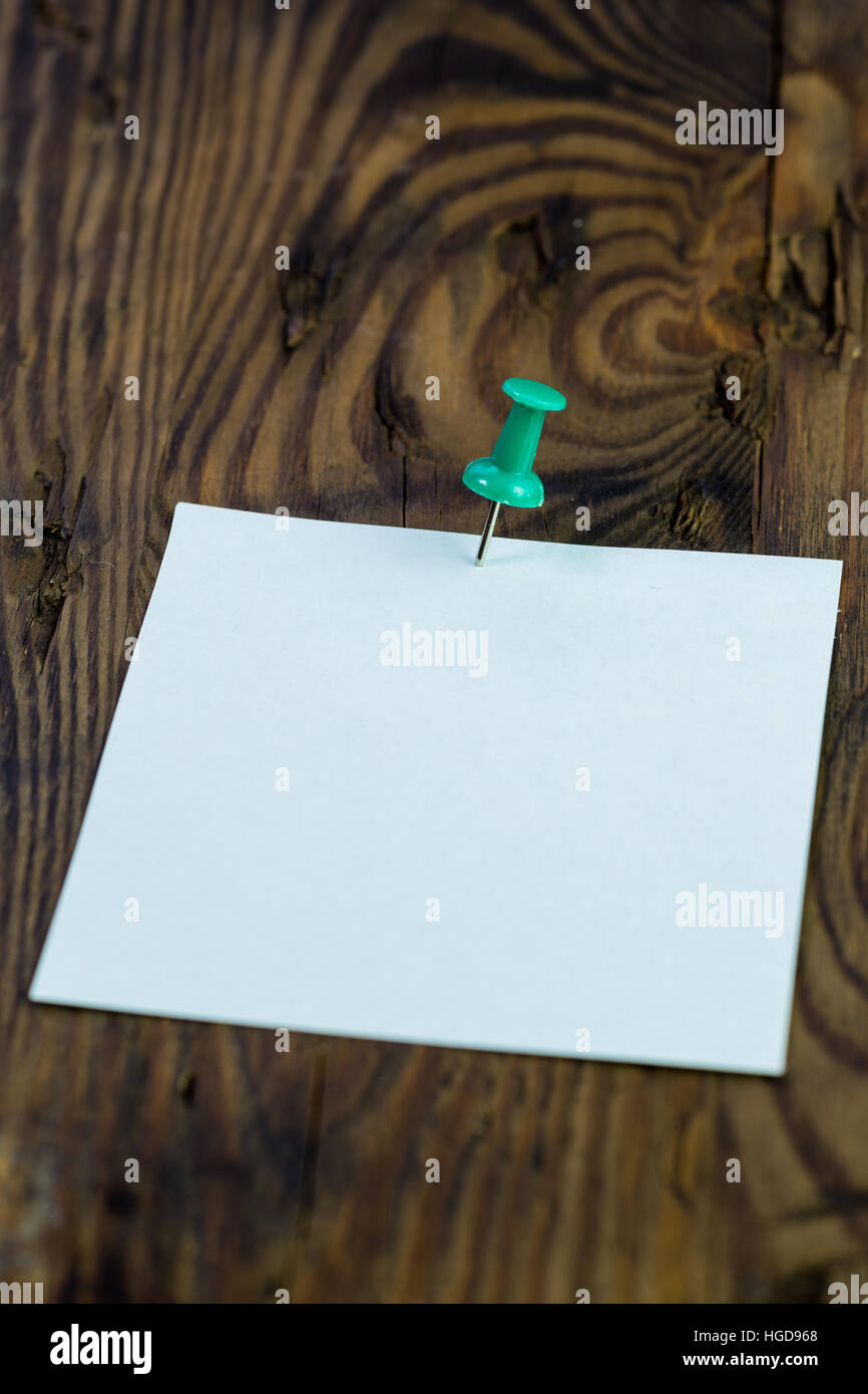 Green thumbtack pins note to distressed wood, shallow DOF Stock Photo ...