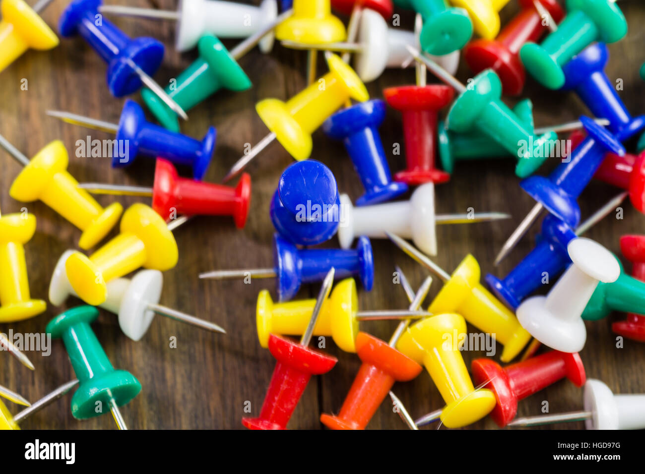 Pile of various color thumbtacks on distressed wood Stock Photo - Alamy