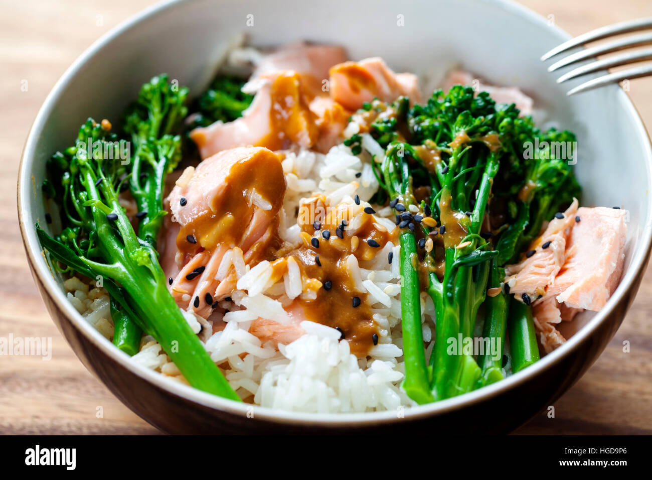 Poached salmon with rice, broccoli and miso sauce Stock Photo - Alamy