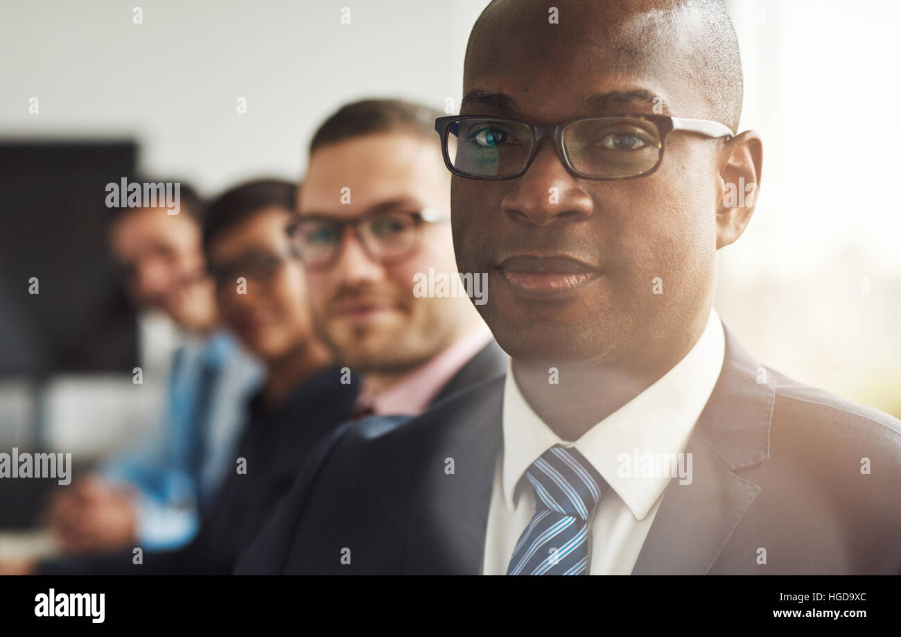 Handsome black business man with three employees and back to large ...