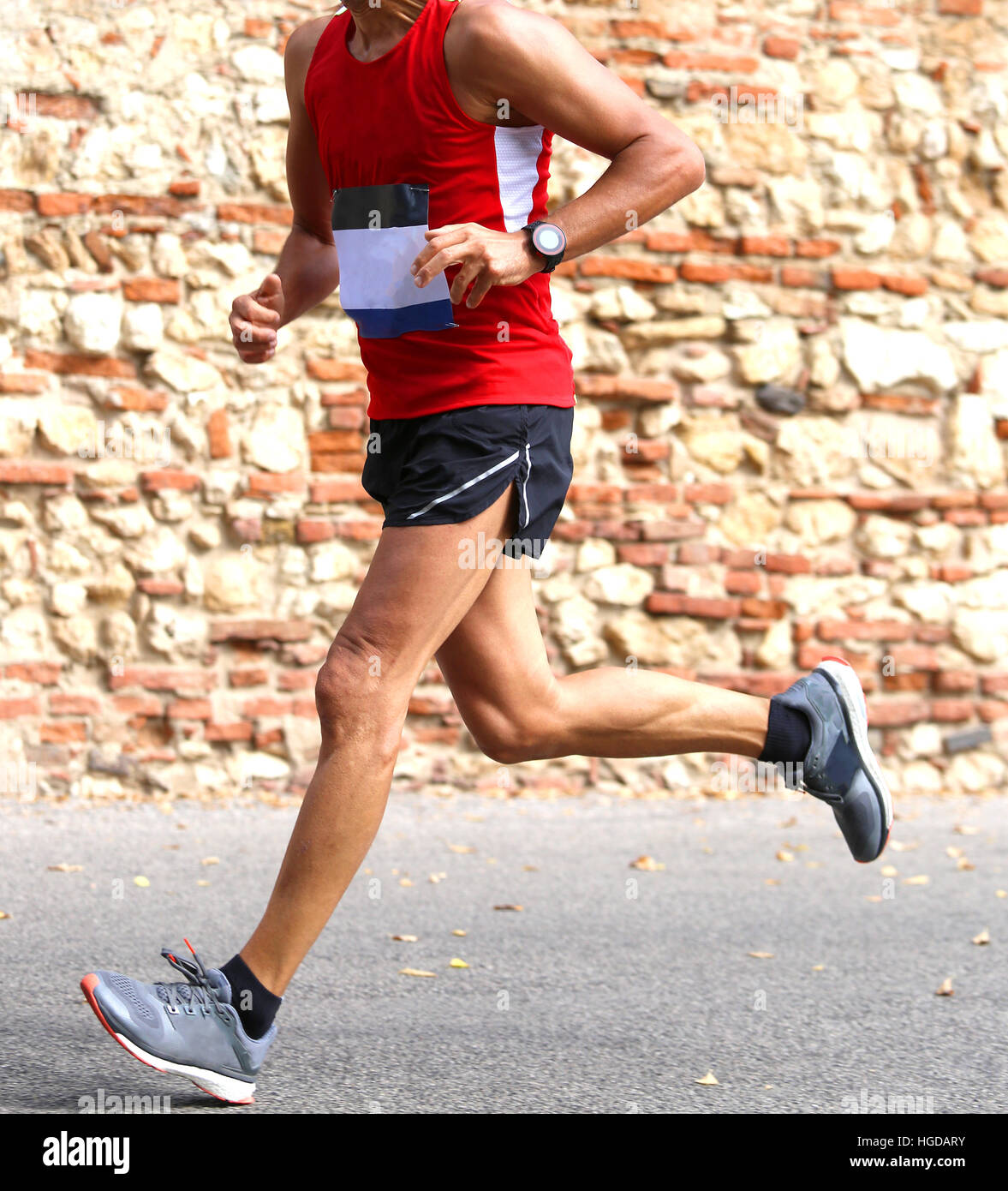 marathon runner runs fast race in town on a paved road Stock Photo - Alamy