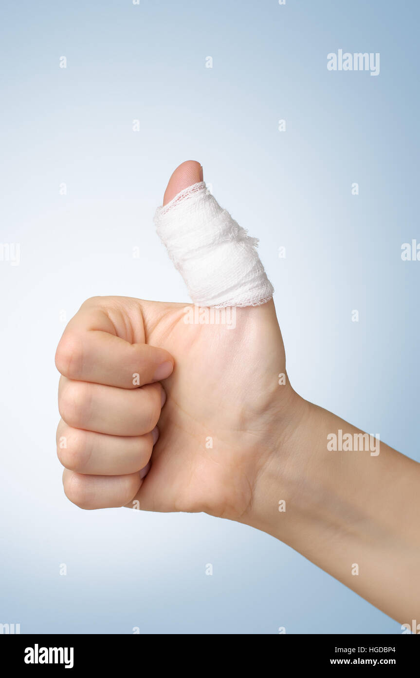 Injured painful finger with white bandage Stock Photo - Alamy