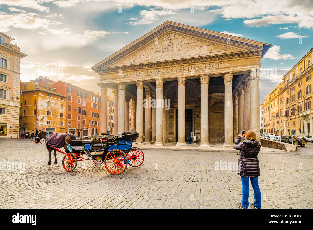 tourist taking photo of monumental building in ancient square in the ...