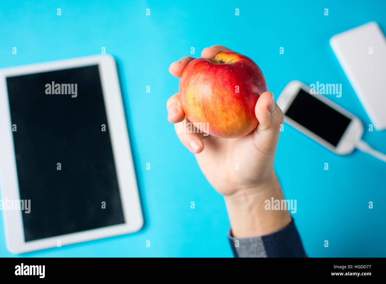 male hand holding an apple at work in the office Stock Photo - Alamy