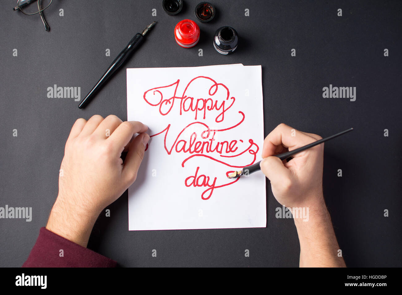male hands writing a Valentine's day card calligraphy Stock Photo - Alamy