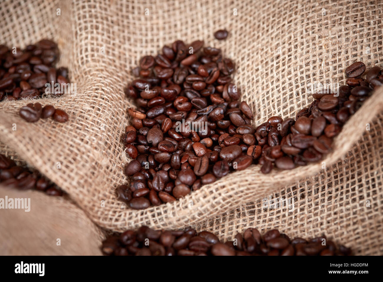 Black coffee beans on brown jute bag as background Stock Photo - Alamy