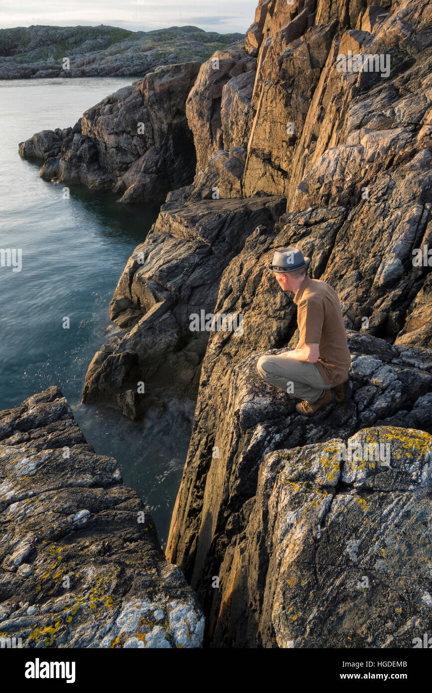 Europe, Great Britain, United Kingdom, Scotland, Lochinver, man sitting ...