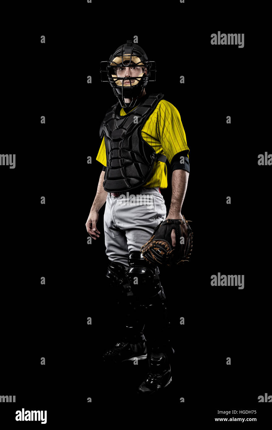 Catcher Baseball Player with a yellow uniform on a black background ...