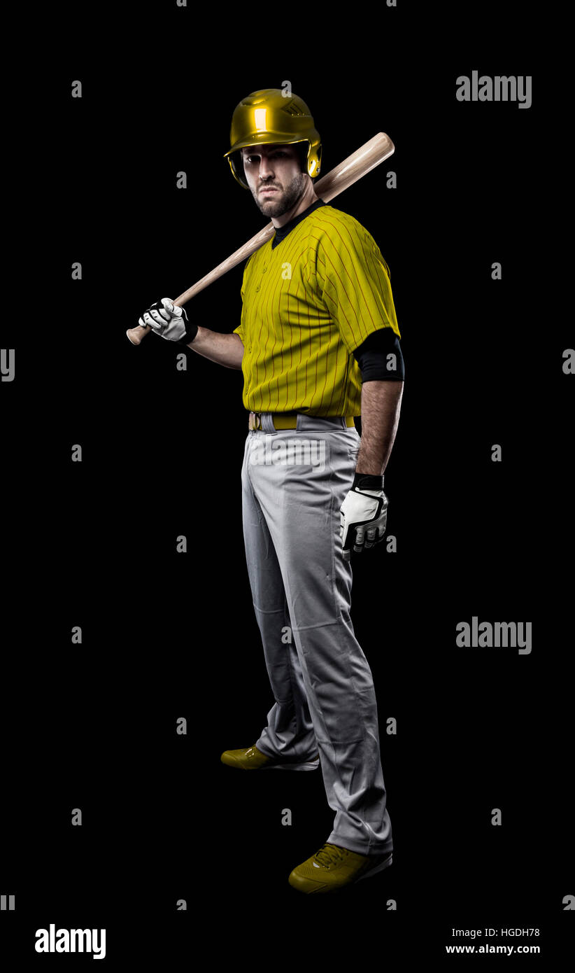 Baseball Player with a yellow uniform on a black background Stock Photo ...