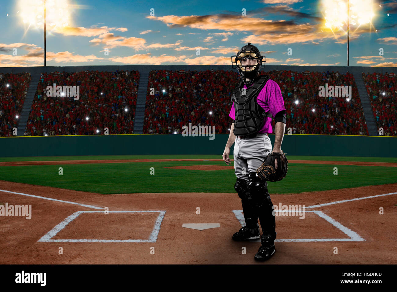 Catcher Baseball Player with a pink uniform on a baseball Stadium Stock ...