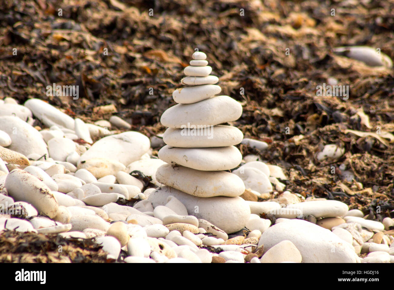 Stack of pebbles balanced on each other on a beach Stock Photo - Alamy