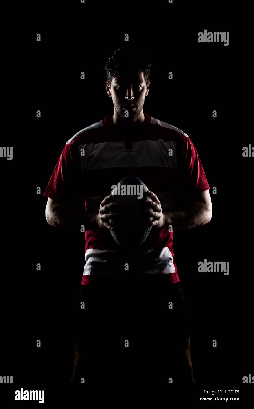 Rugby player in a red uniform. Black Background Stock Photo - Alamy