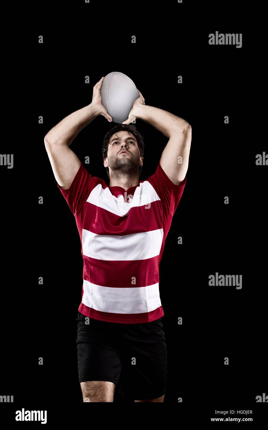 Rugby player in a red uniform. Black Background Stock Photo - Alamy