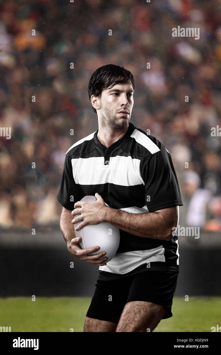 Rugby player in a black and white uniform. on a stadium Stock Photo - Alamy