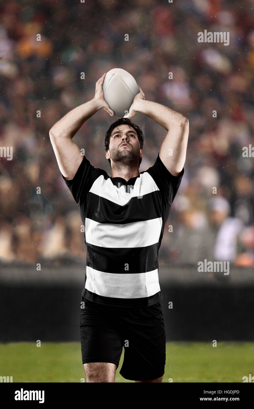 Rugby player in a black and white uniform on a stadium Stock Photo - Alamy