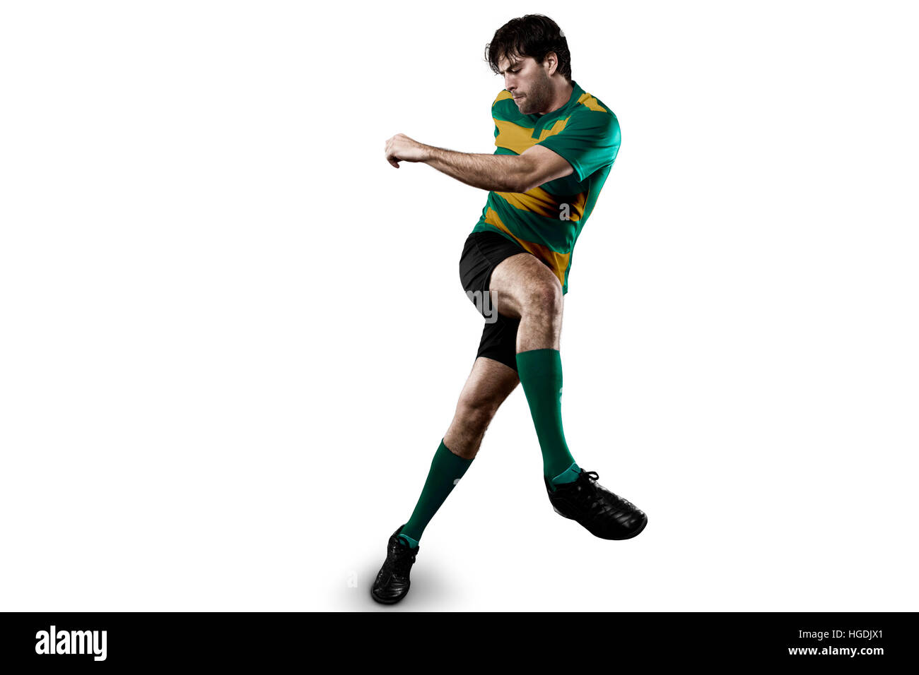 Rugby player in a green and gold uniform kicking. White Background ...