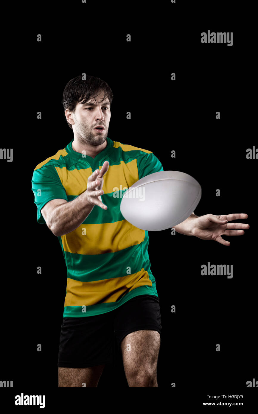 Rugby player in a green and gold uniform. black Background Stock Photo ...