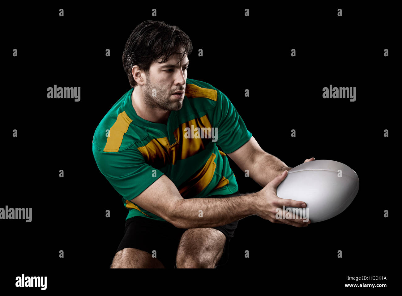 Rugby player in a green and gold uniform. Black Background Stock Photo ...