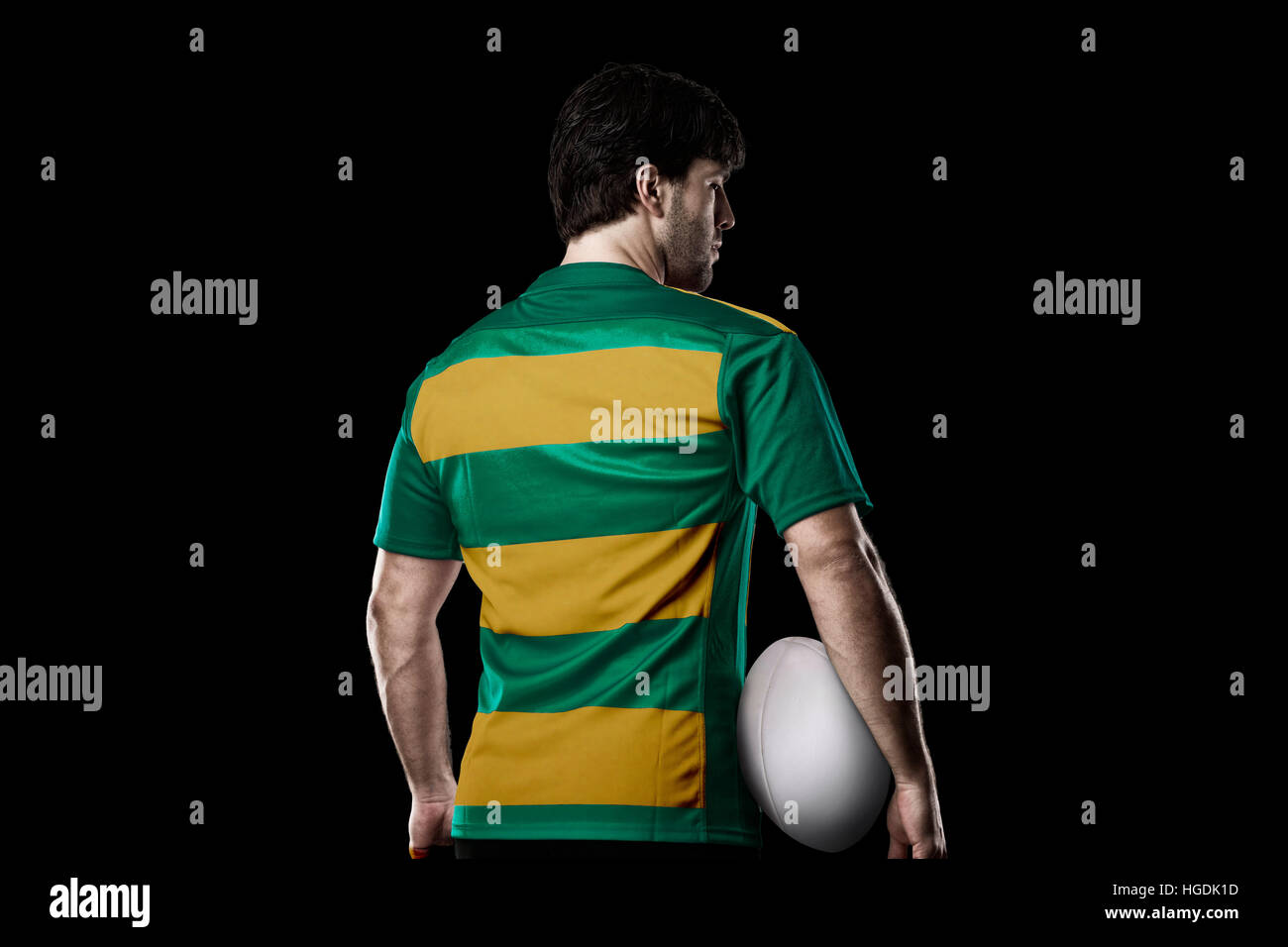 Rugby player in a green and gold uniform. Black Background Stock Photo ...