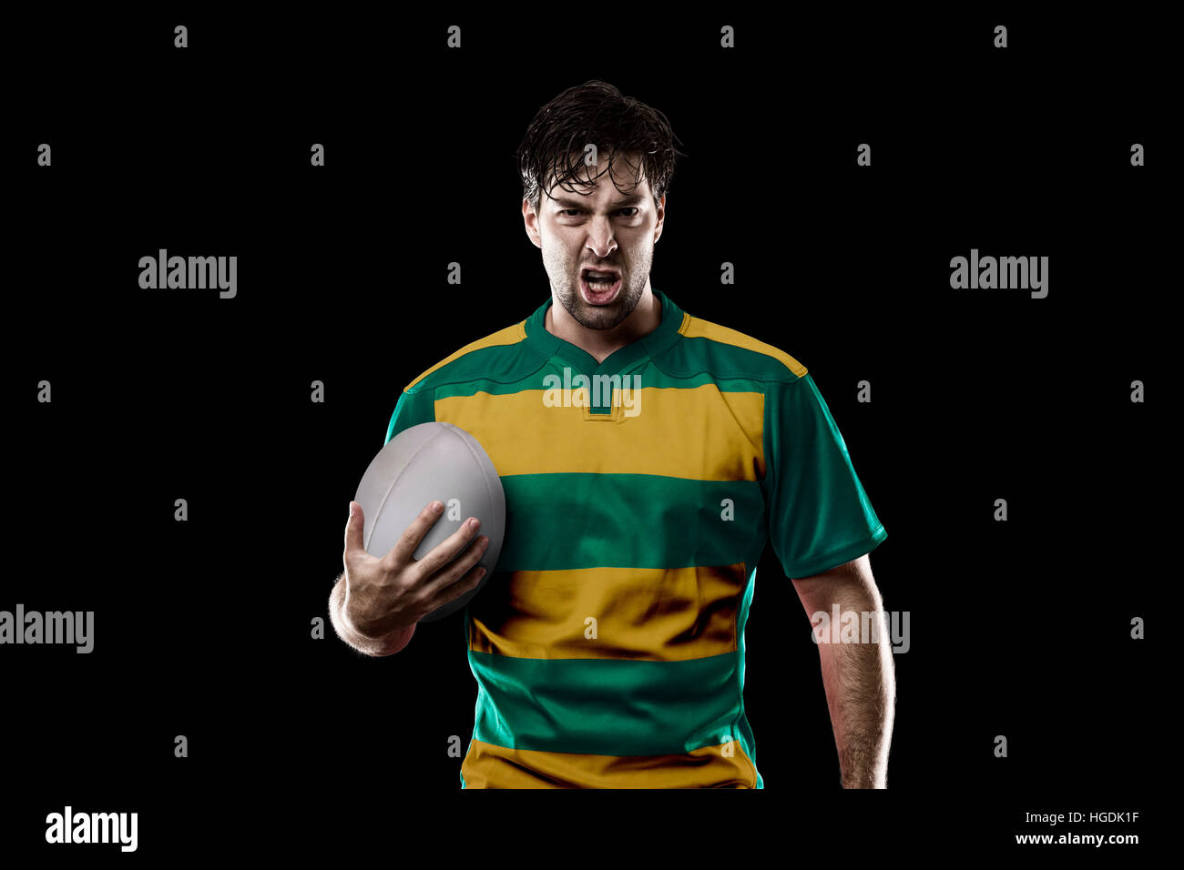 Rugby player in a green and gold uniform. Black Background Stock Photo ...