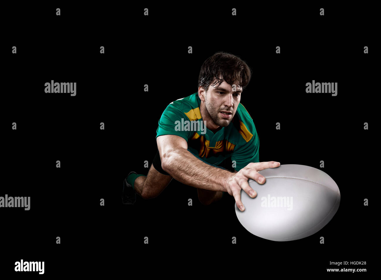 Rugby player in a green and gold uniform. Black Background Stock Photo ...