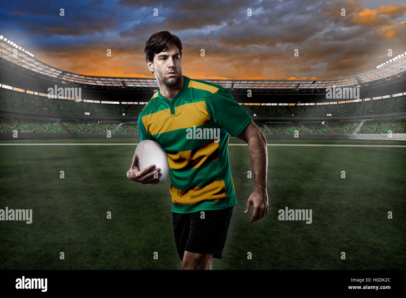 Rugby player in a green and gold uniform on a stadium Stock Photo - Alamy