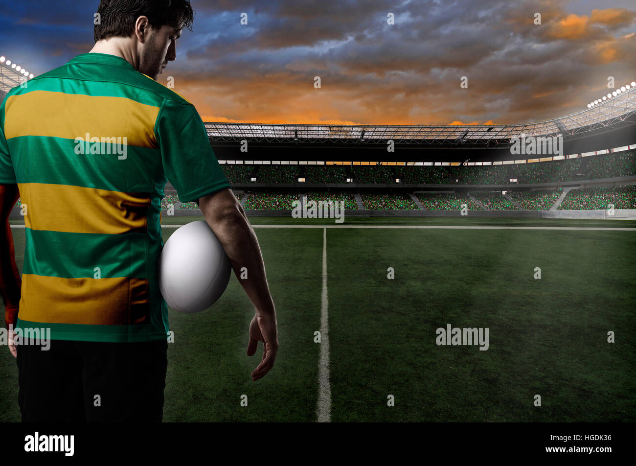 Rugby player in a green and gold uniform on a stadium Stock Photo - Alamy