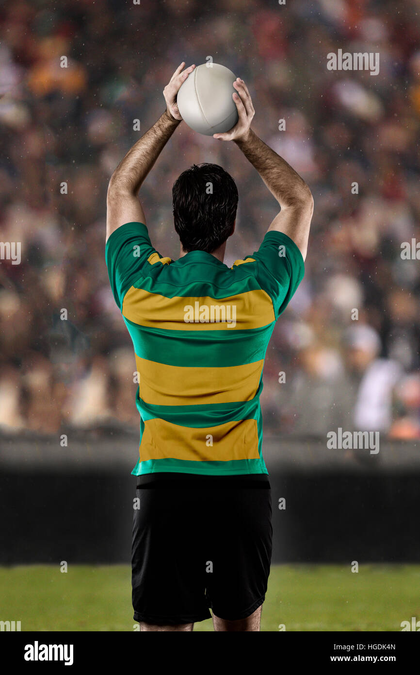 Rugby player in a green and gold uniform on a stadium Stock Photo - Alamy