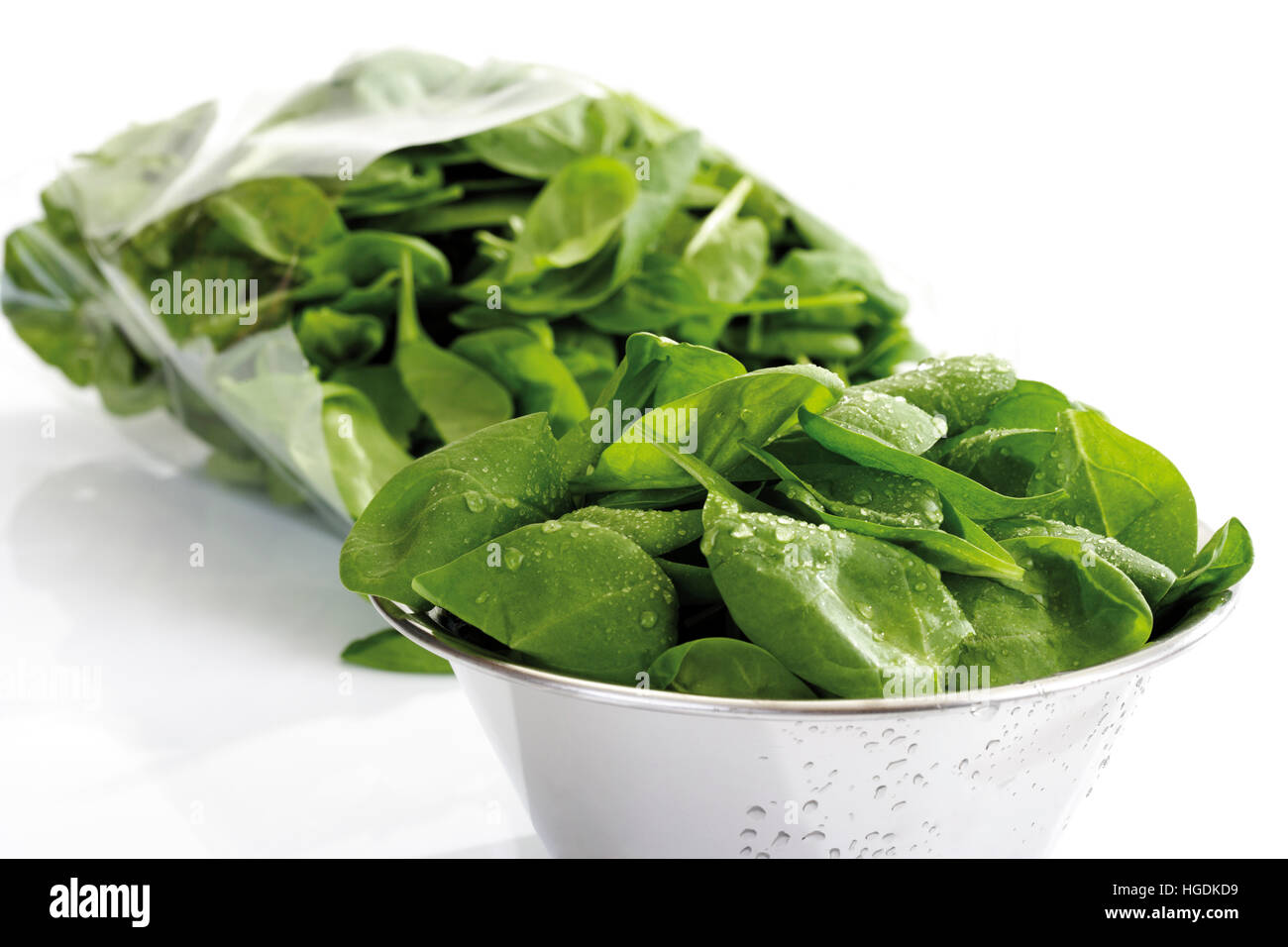 Bowl of baby spinach, package of spinach in background Stock Photo - Alamy