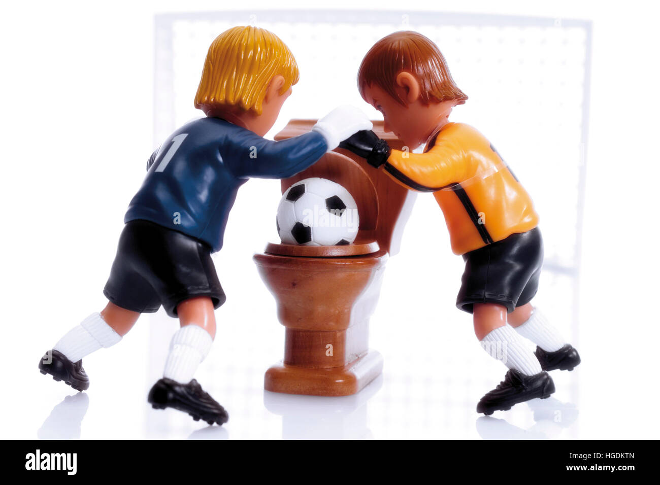 Football in the toilet: symbol for losing the ball Stock Photo - Alamy