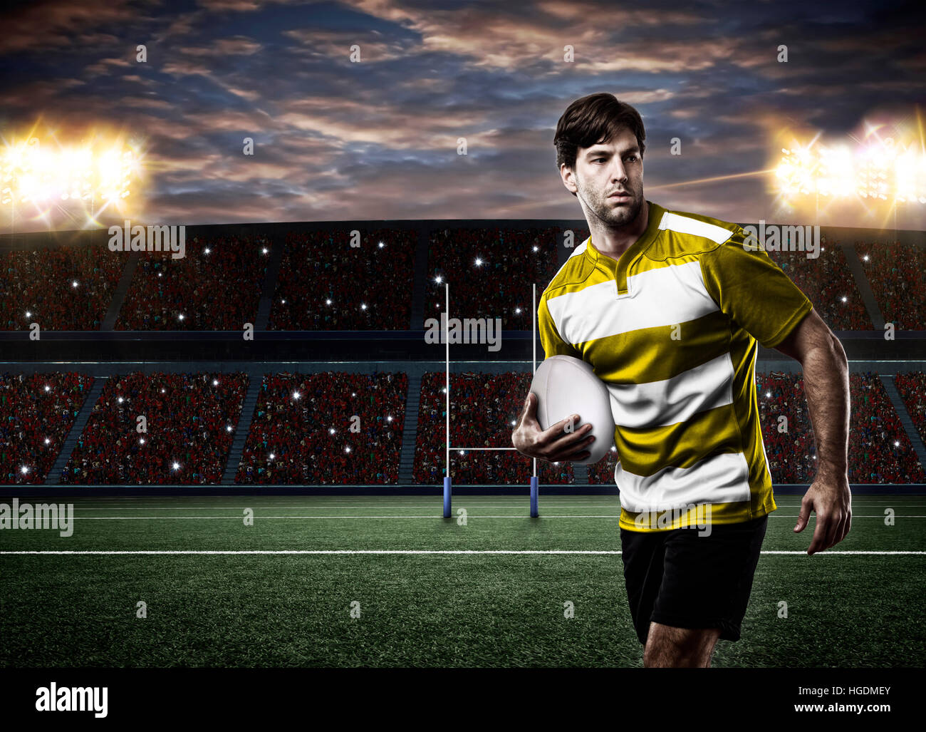 Rugby player in a yellow uniform on a stadium Stock Photo - Alamy