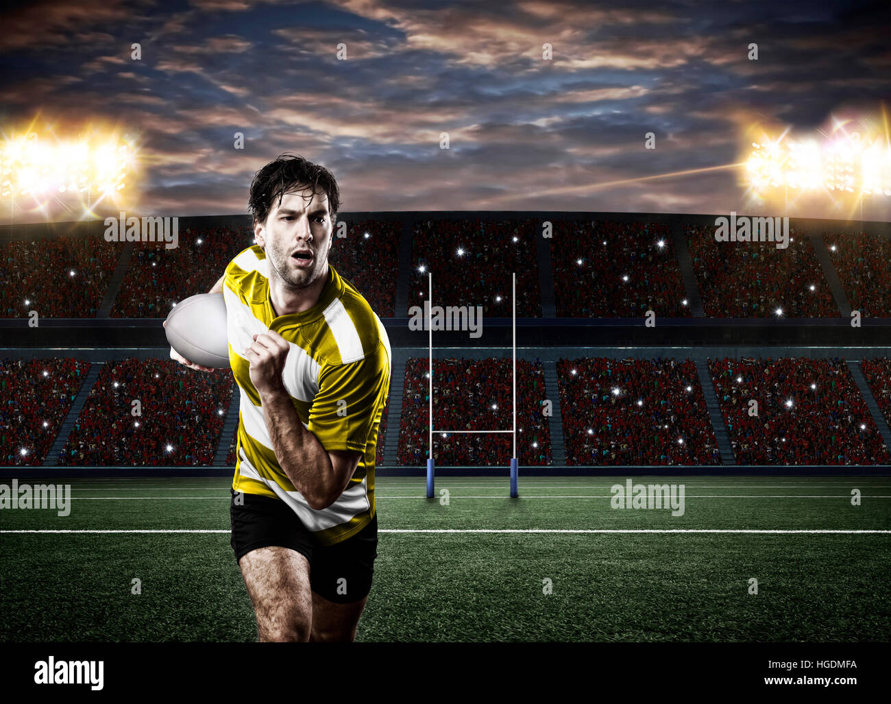 Rugby player in a yellow uniform running on a stadium Stock Photo - Alamy