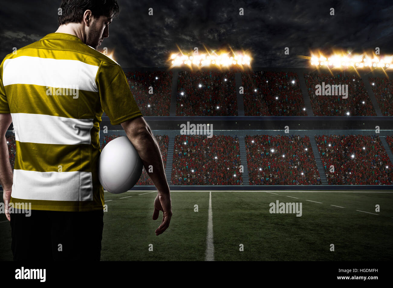 Rugby player in a yellow uniform on a stadium Stock Photo - Alamy