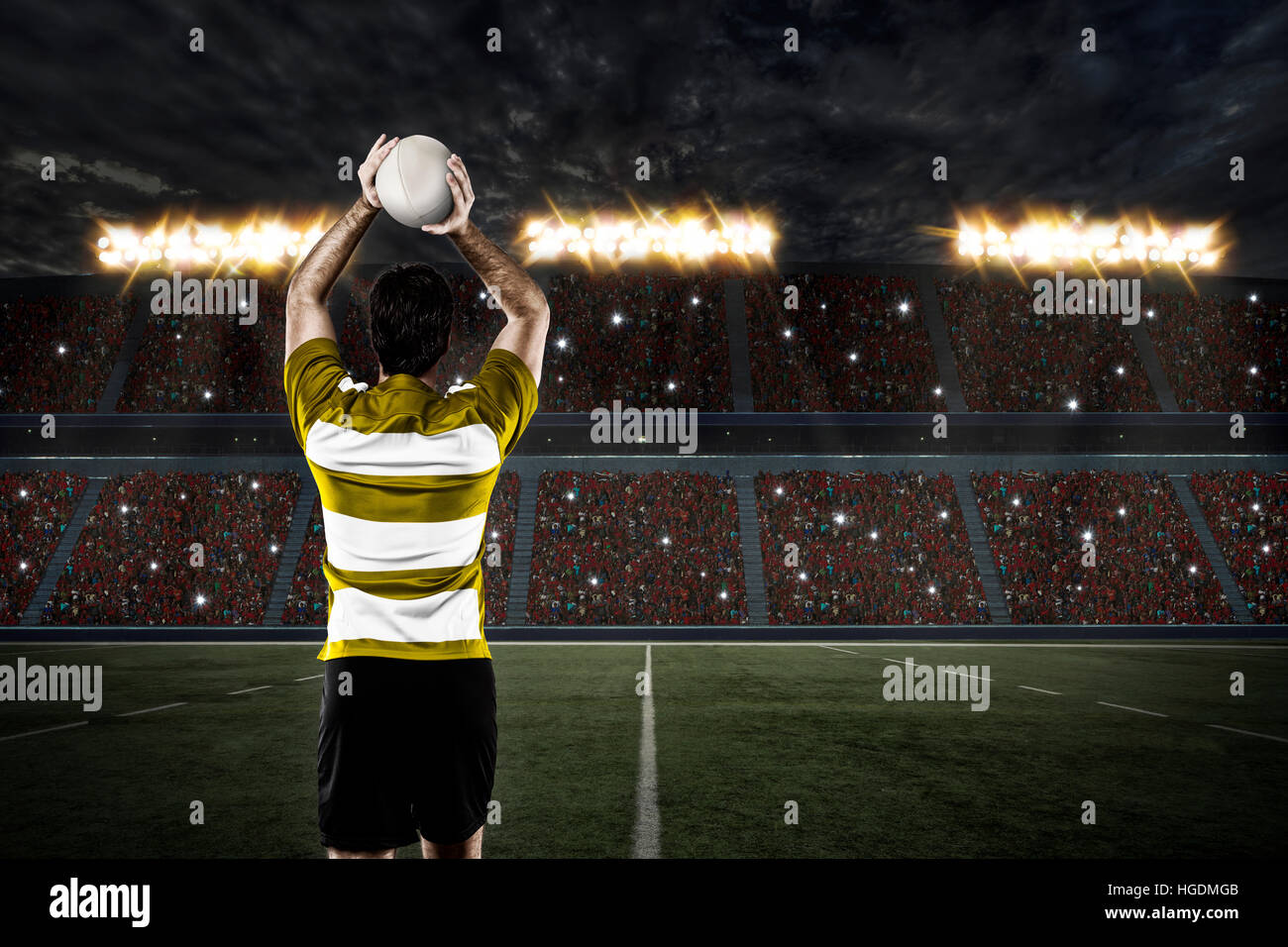 Rugby player in a yellow uniform on a stadium Stock Photo - Alamy
