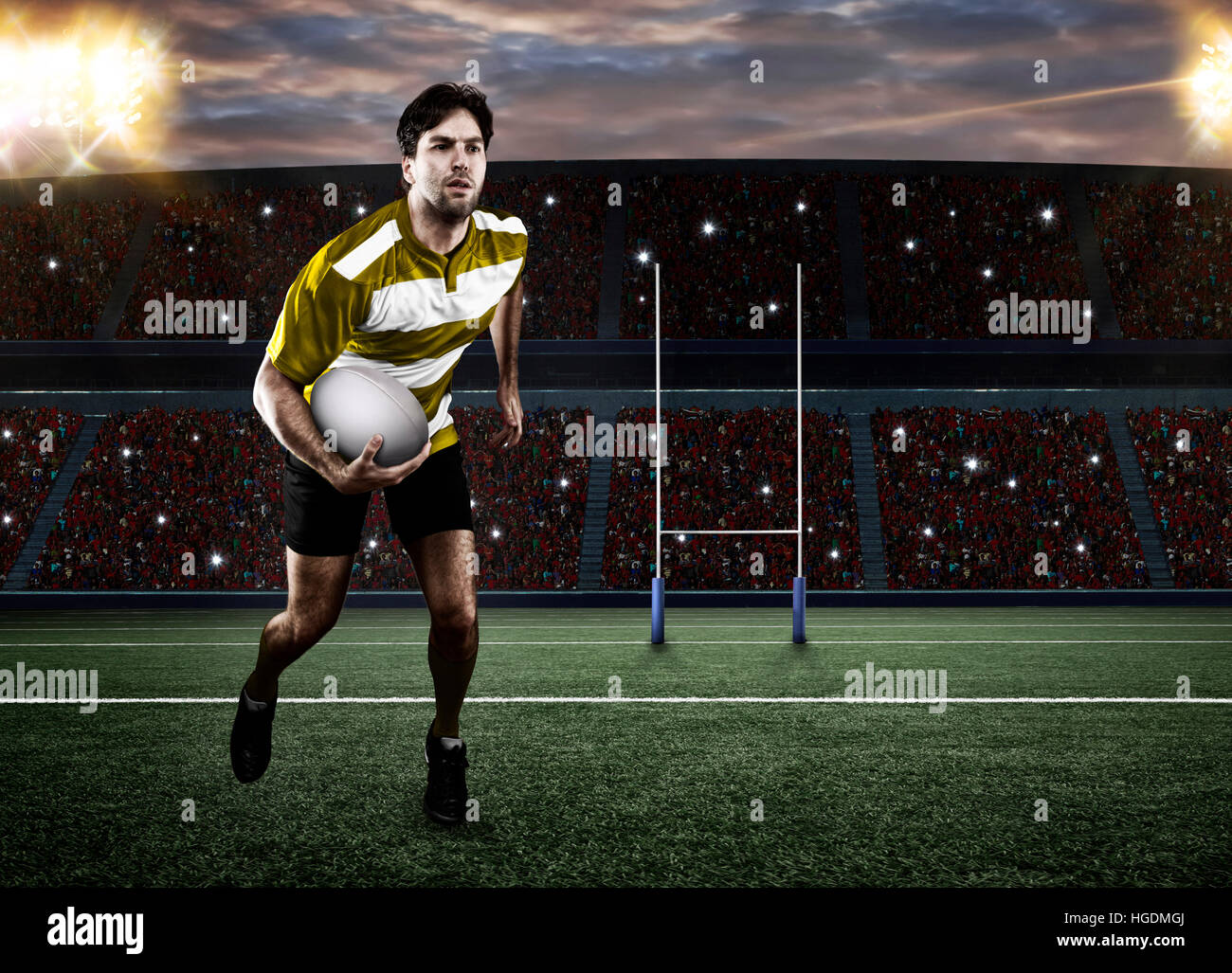 Rugby player in a yellow uniform running on a stadium Stock Photo - Alamy